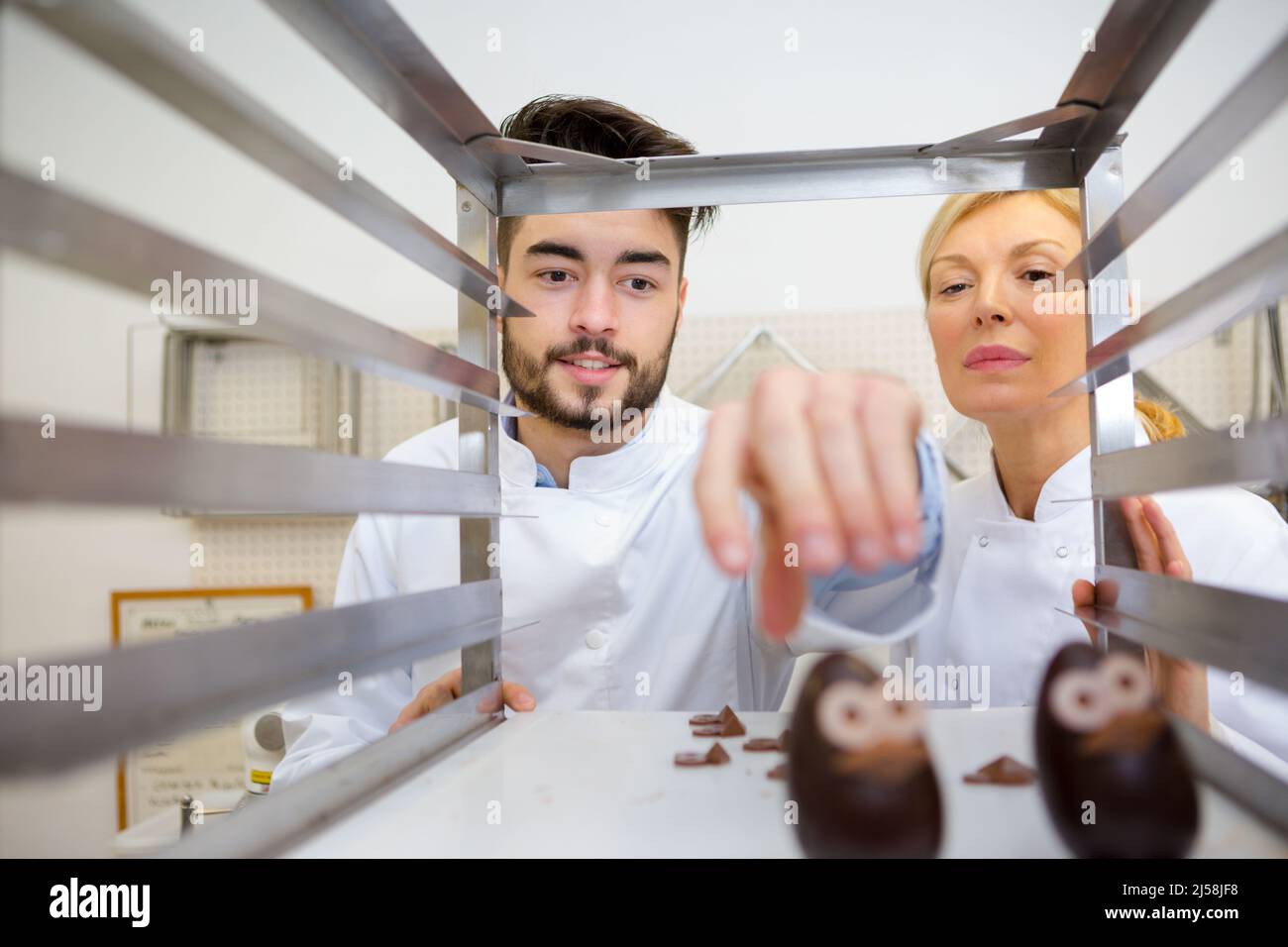 professional chefs looking at little novelyty chocolate hats Stock ...
