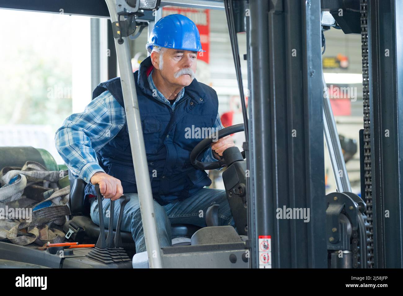 Smiling man operating forklift hi-res stock photography and images - Alamy