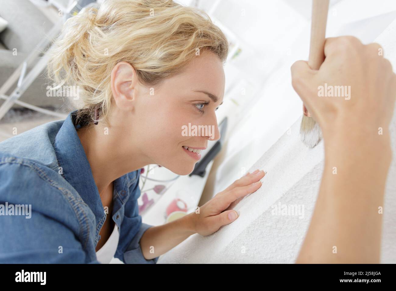 woman painting wall Stock Photo - Alamy