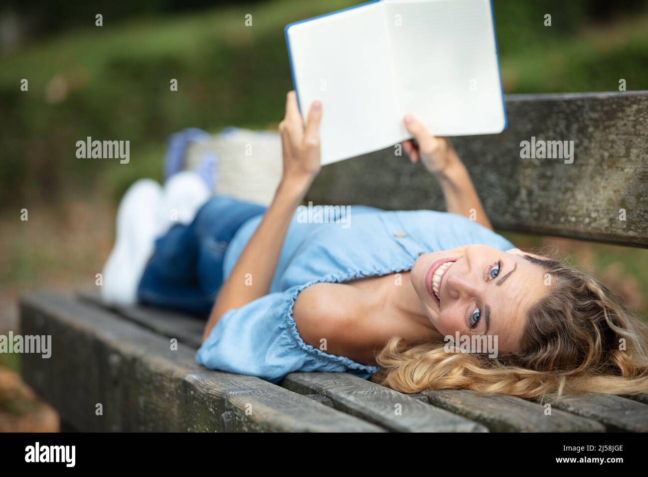 smart lady relaxing on a bench Stock Photo - Alamy