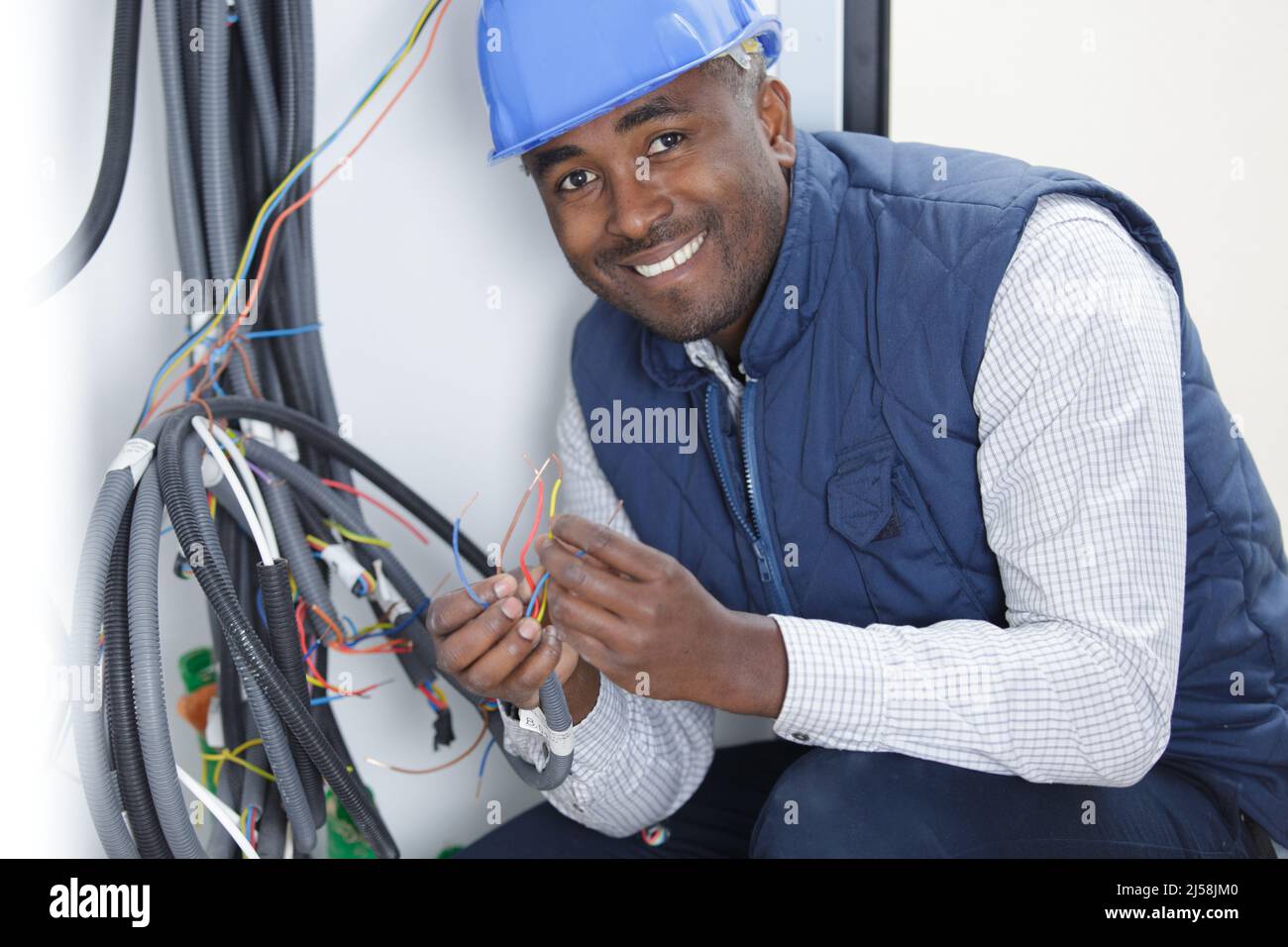 electrician working near the board with wires installation and ...