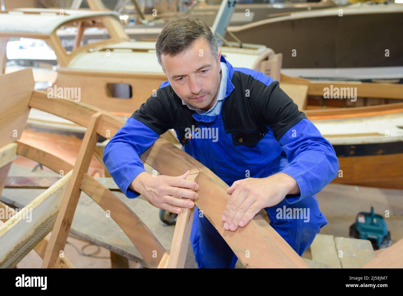 a man is making wooden boat Stock Photo - Alamy