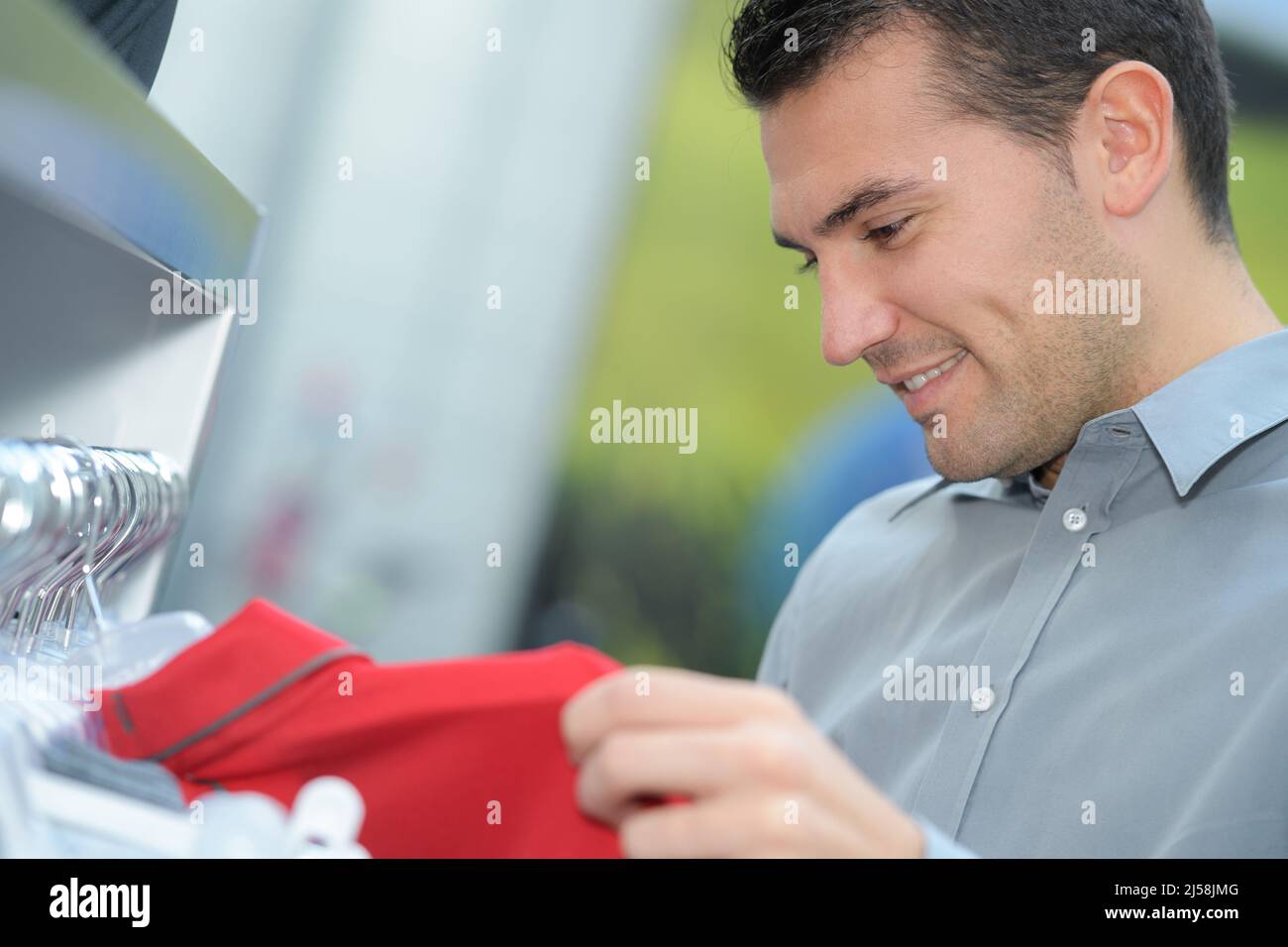 Male shop assistant clothes shop hi-res stock photography and images ...