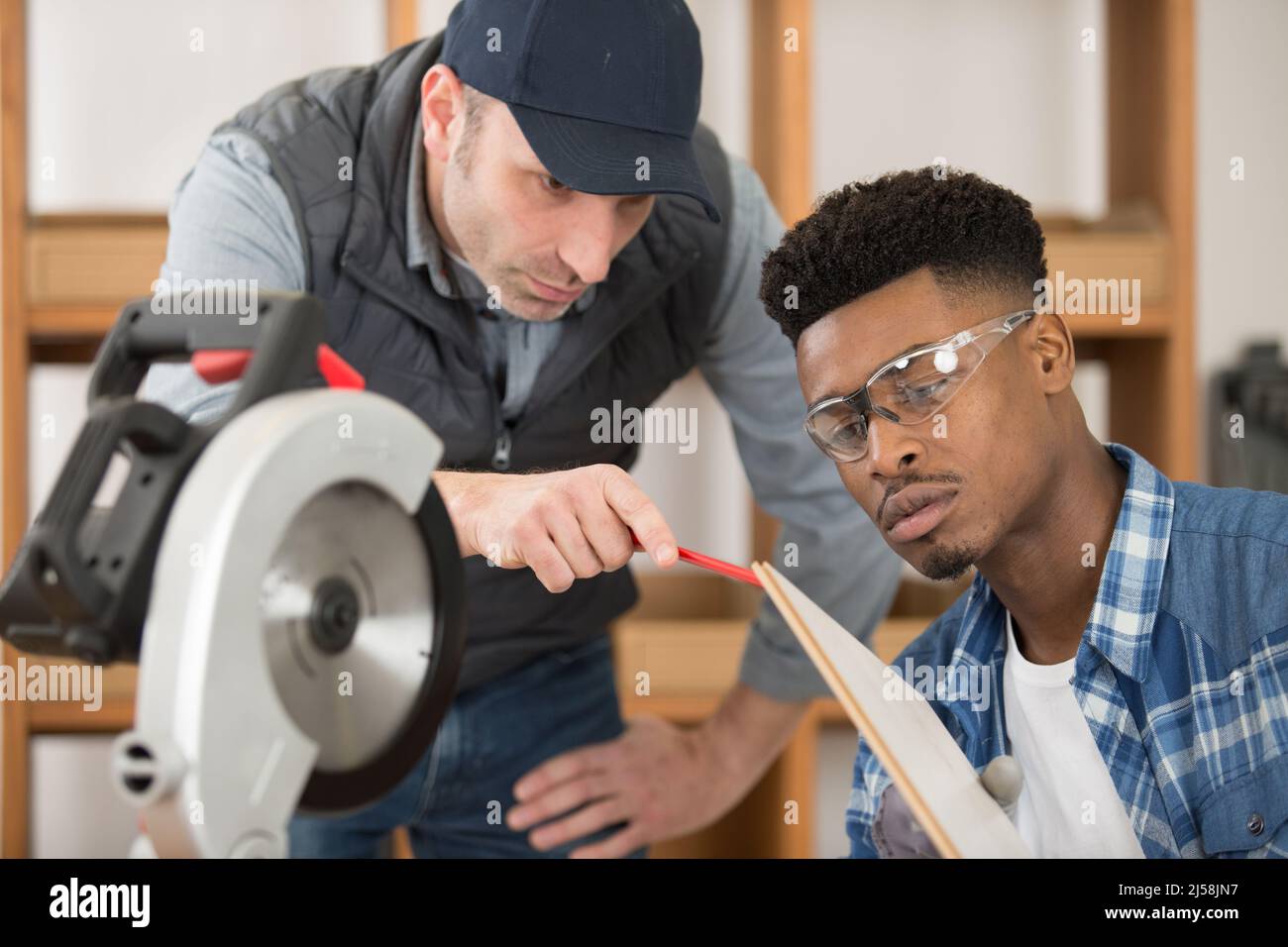 student and teacher in carpentry class using circular saw Stock Photo ...