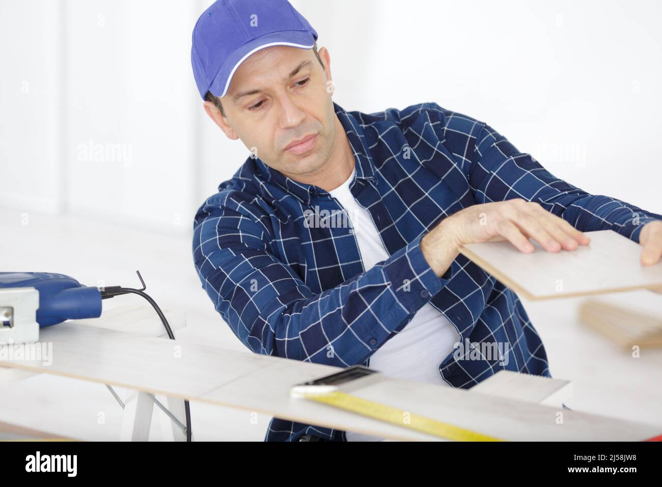 carpenter cutting wood on electric saw Stock Photo - Alamy