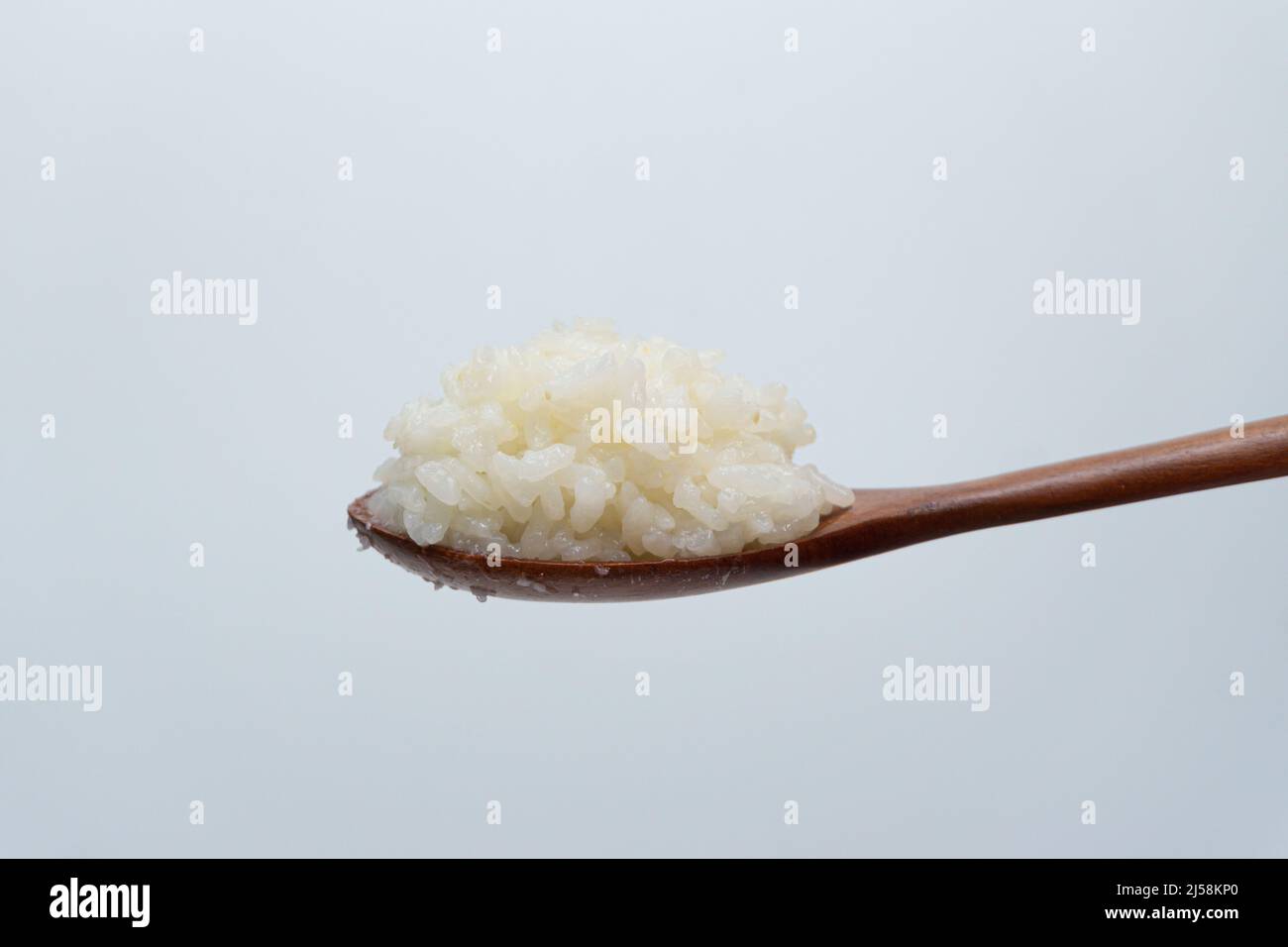 White rice and seaweed on a spoon on a white background Stock Photo - Alamy