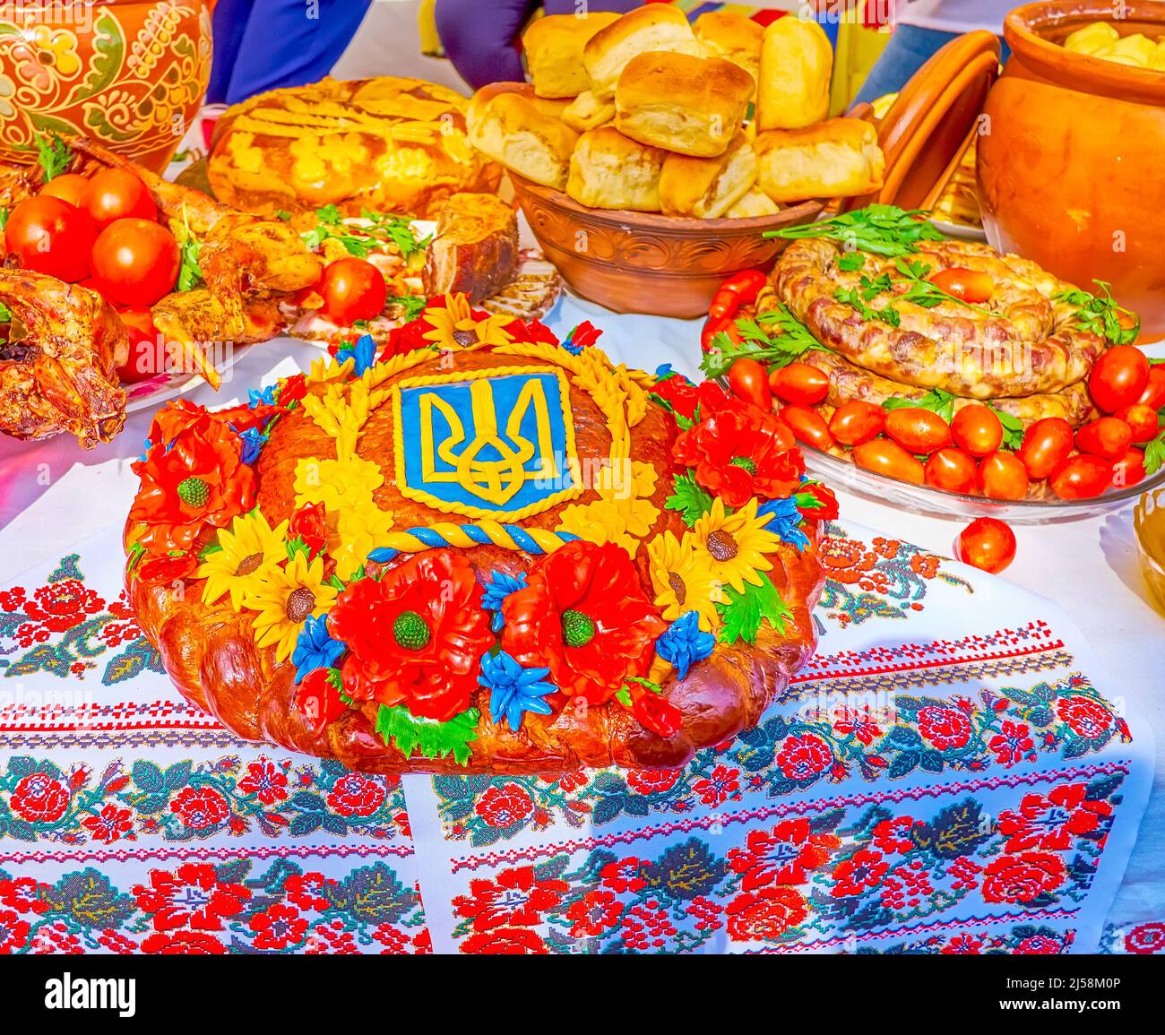 The big and scenic korovai bread decorated with colorful flowers and ...