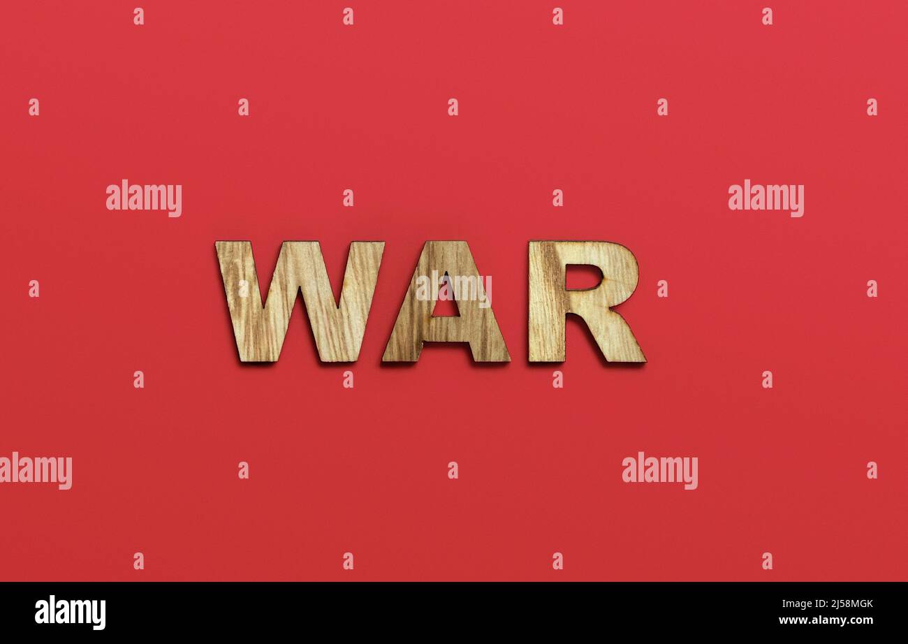WAR, word written in wooden alphabet letters on red background. The ...
