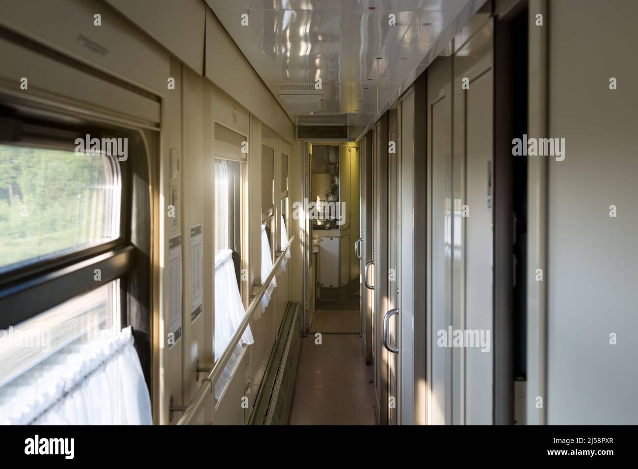 An empty corridor of a railway carriage compartment. The concept of ...