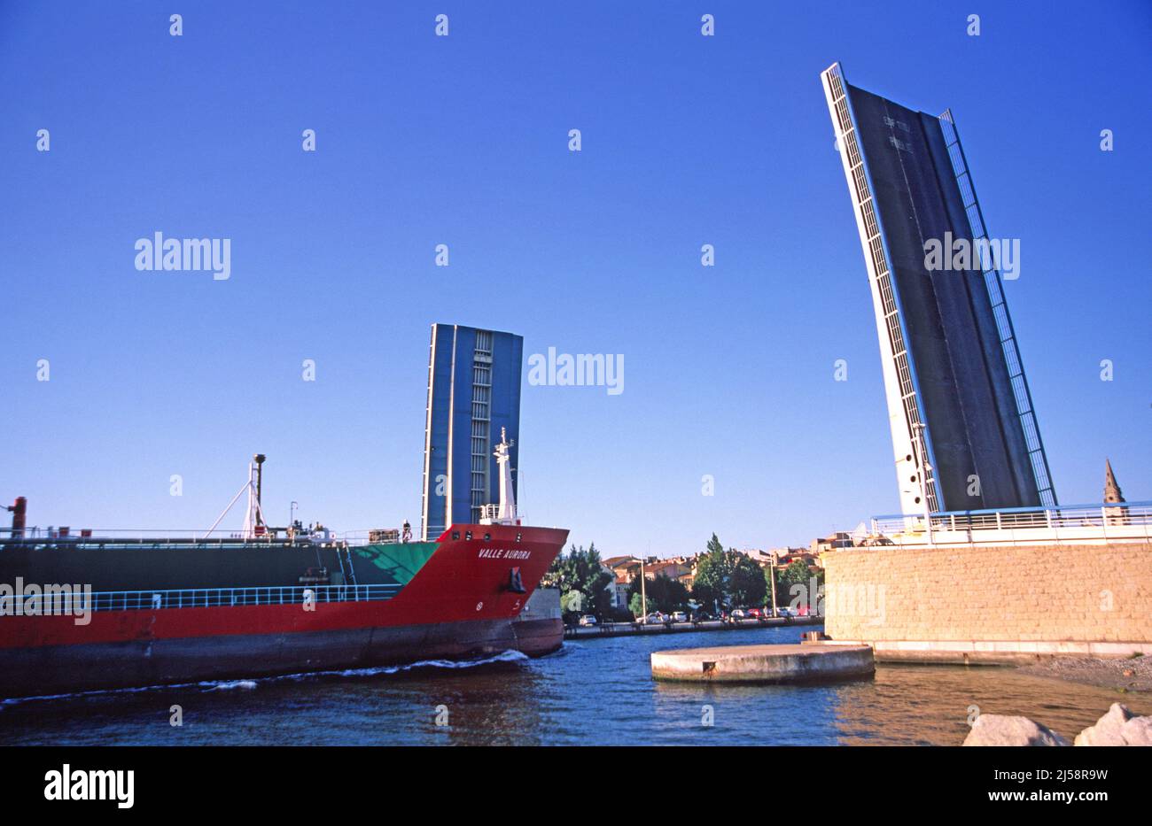 Tanker on the Caronte Canal crossing a raised bridge at Marigues Stock ...