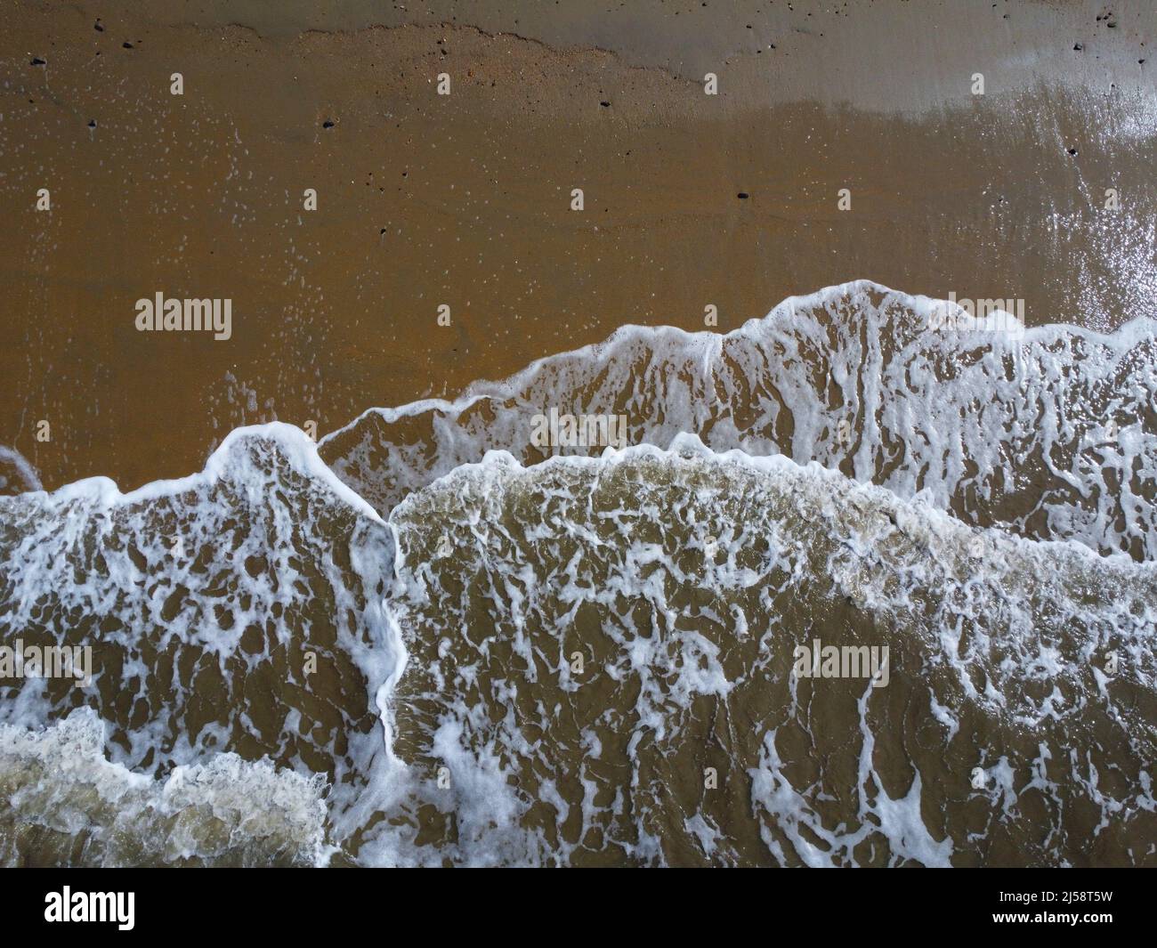 Aerial down view of whit waves washing on the beach Stock Photo - Alamy
