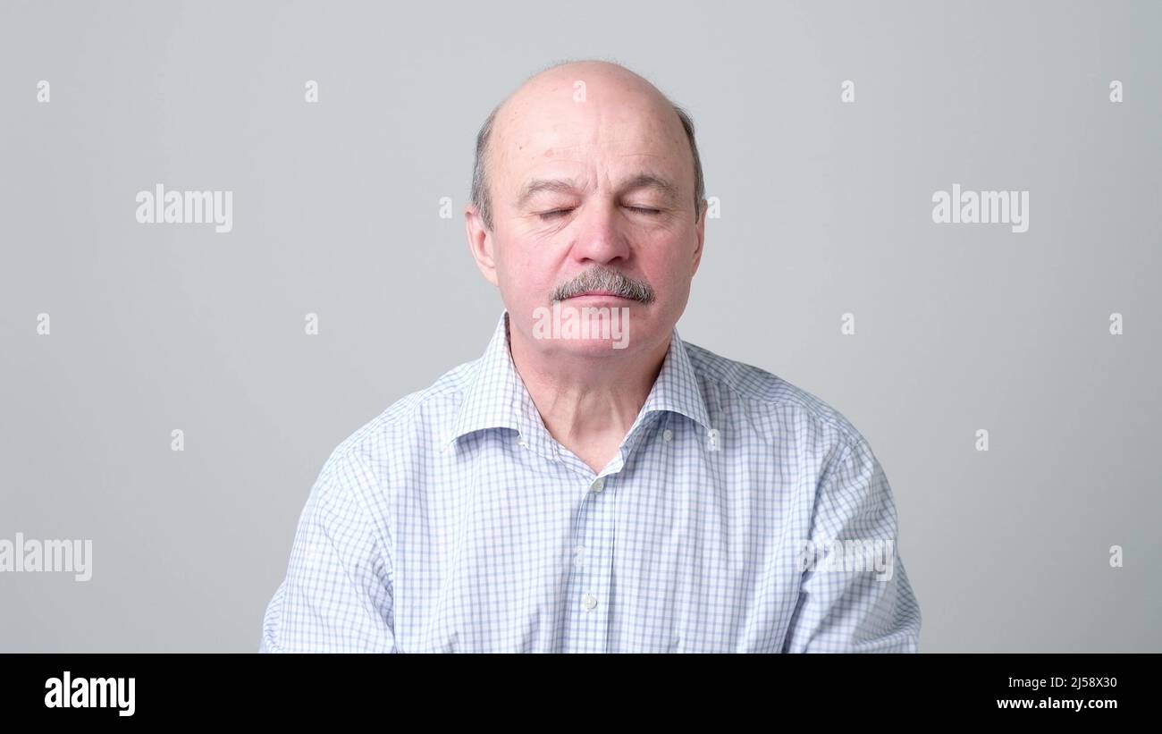 Senior bald european man feeling tired and sleepy after long hard ...