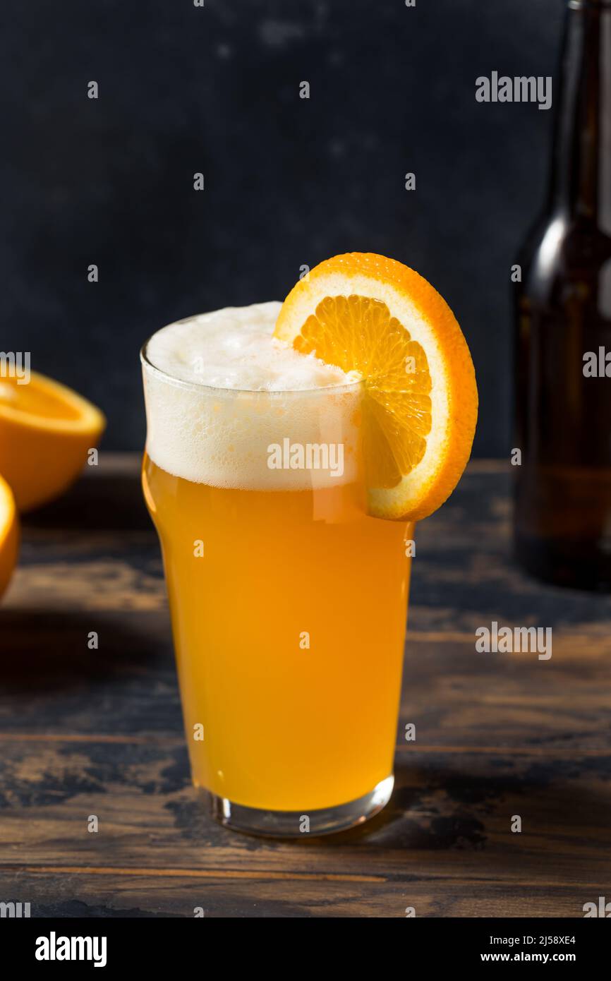 Boozy Belgian Orange Wheat Beer with a Garnish Stock Photo - Alamy