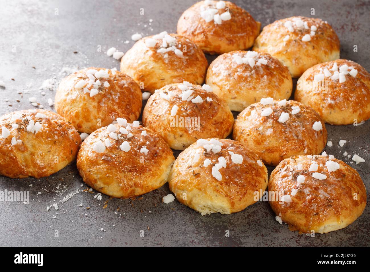 Homemade sweet hot bath bun with cumin and sugar close-up on the table ...