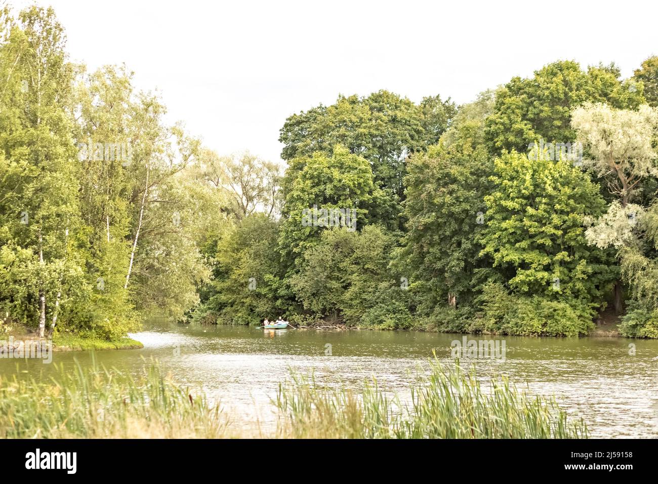 A boat floating on the lake. Spring Park. Nature. Rest. Couple in love ...
