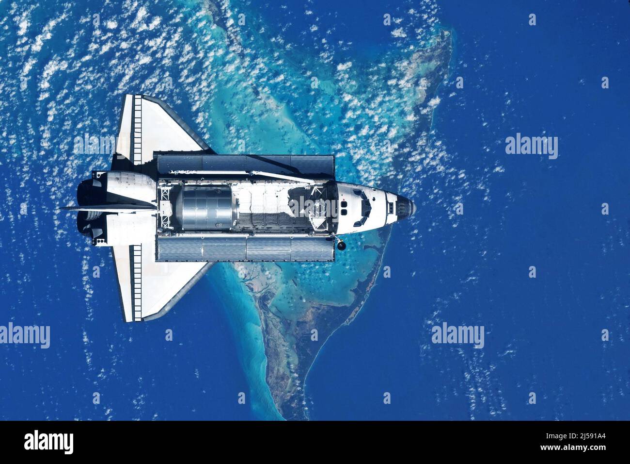 Space shuttle over the planet. Elements of this image furnished by NASA ...