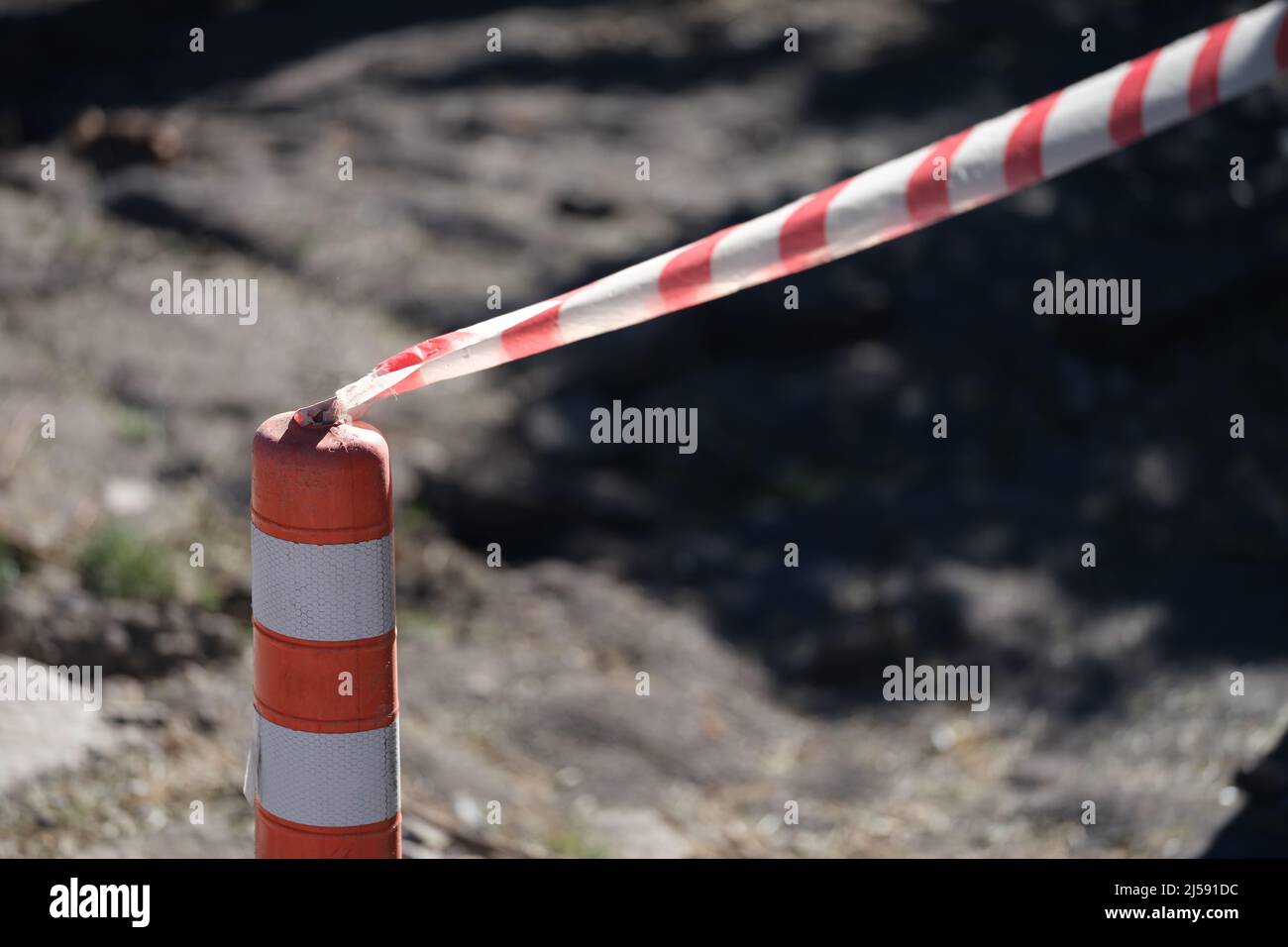 Red and white tape stretched in front of danger zone closeup Stock ...