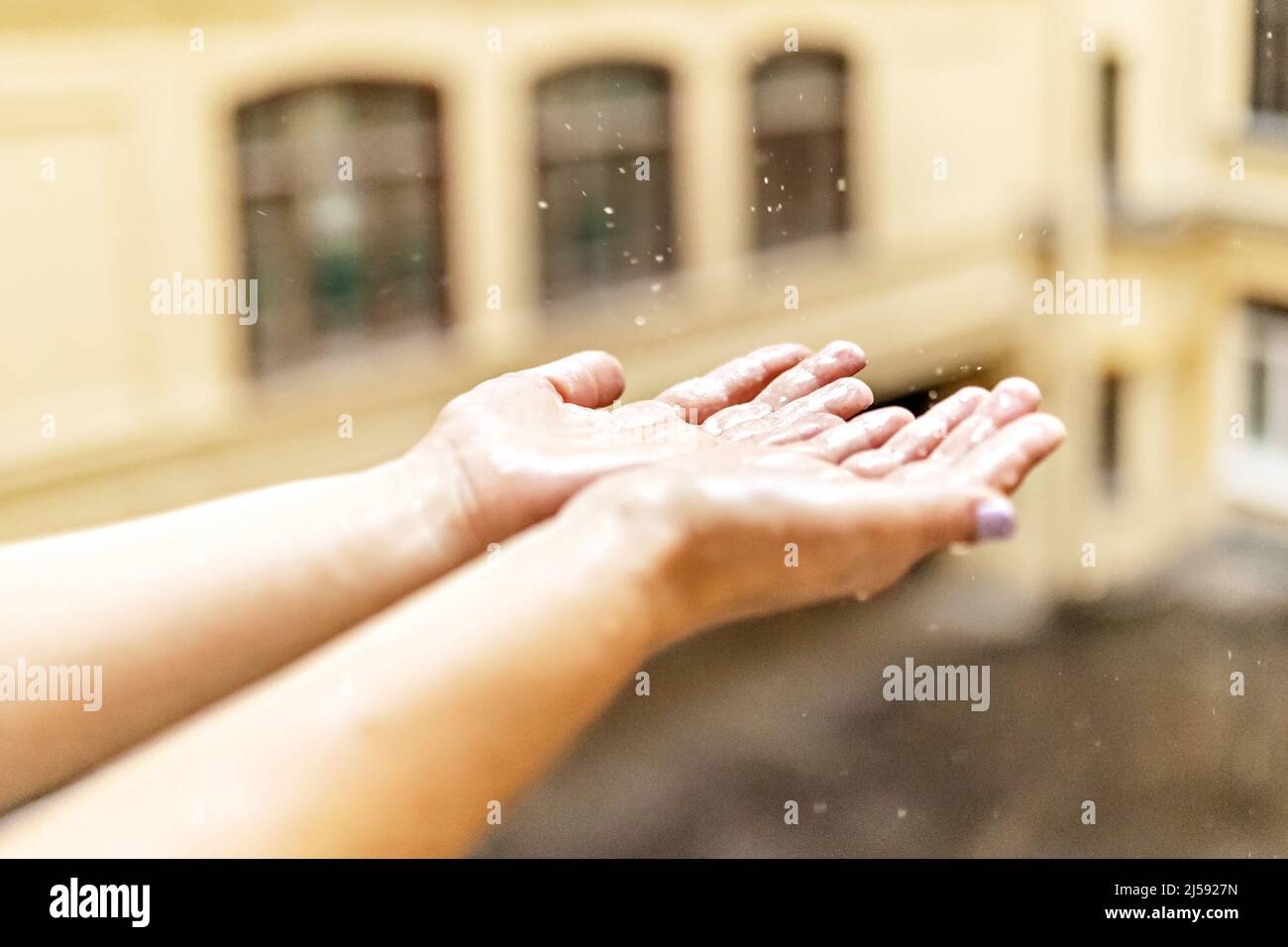 Women's hands in the rain, raindrops fall into their hands, catch Stock ...