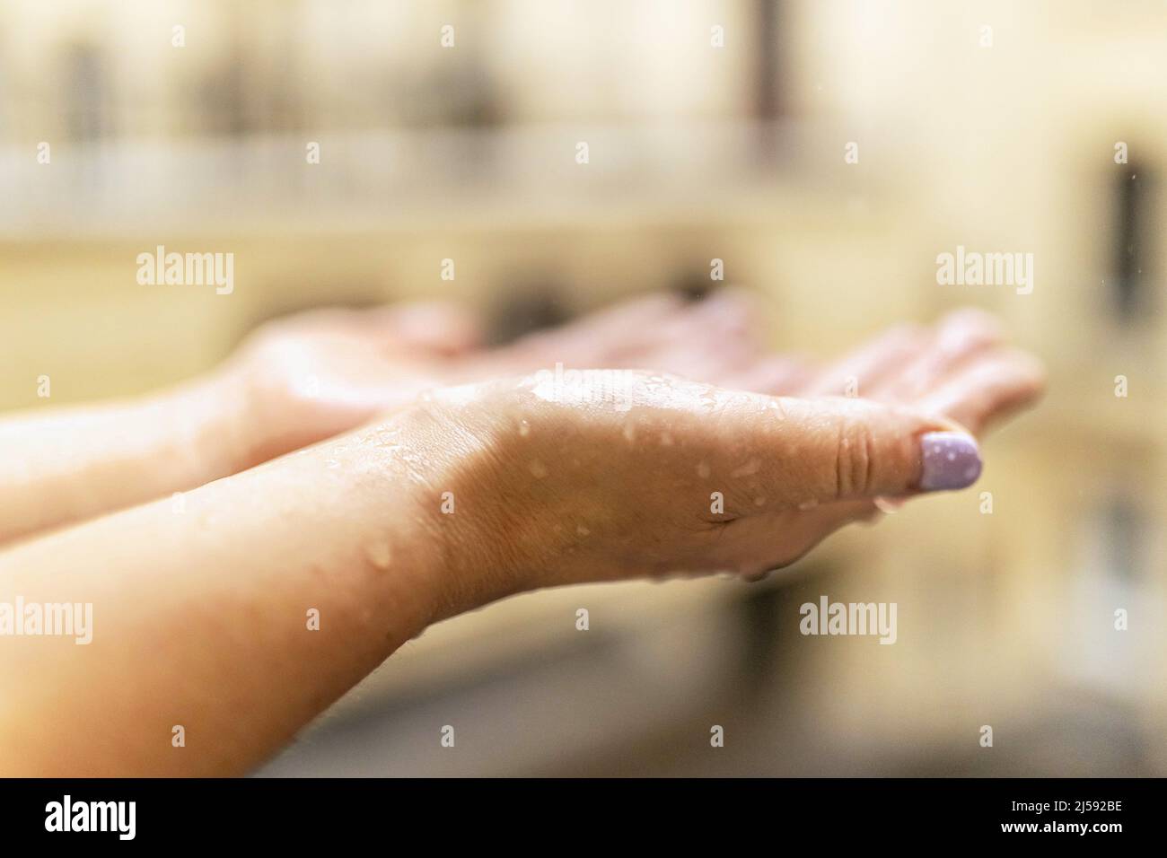 Women's hands in the rain, raindrops fall into their hands, catch Stock ...