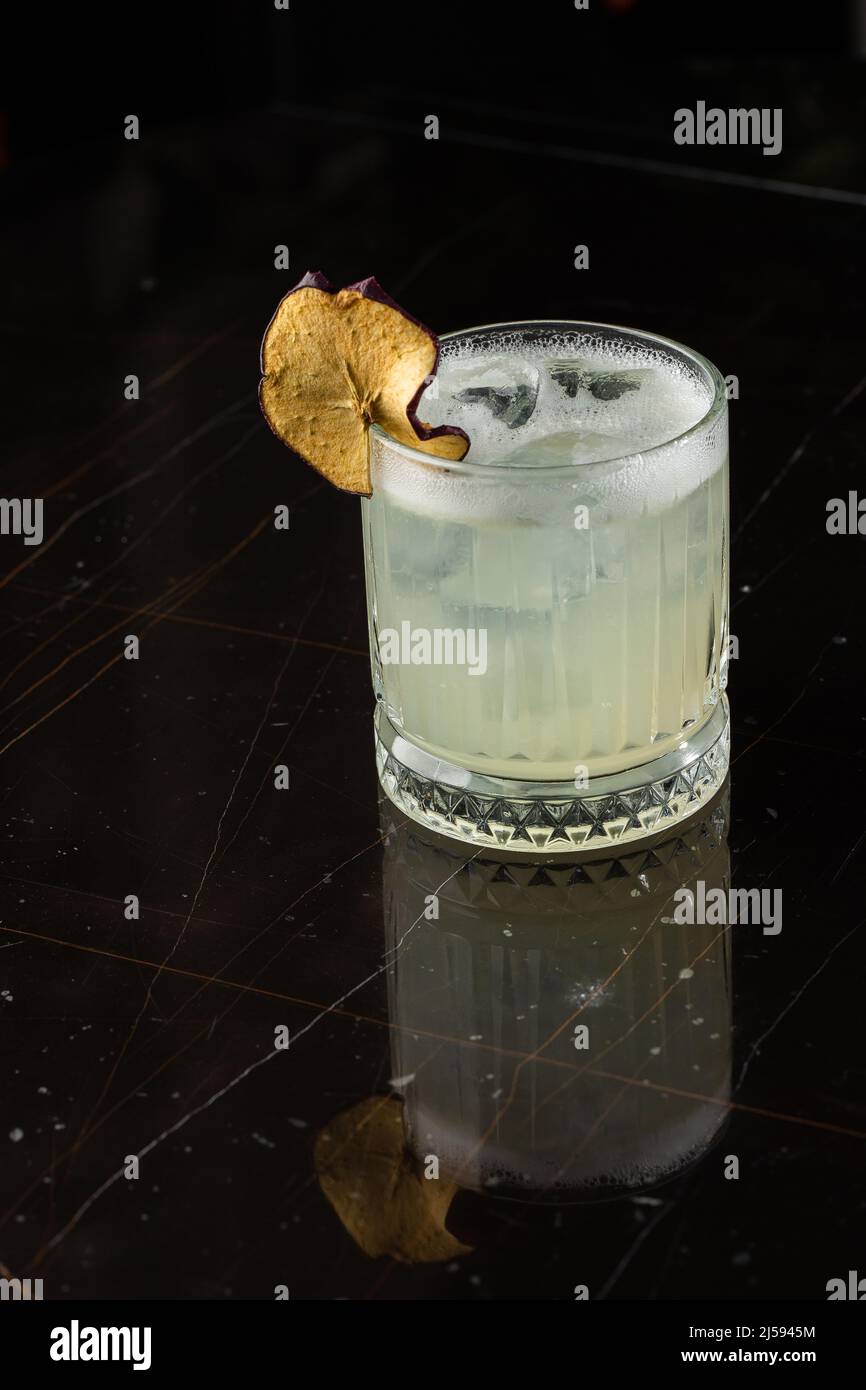 Classic cocktail glass on glass table in night club restaurant. Alcohol ...