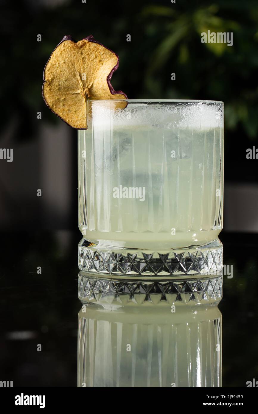 Classic cocktail glass on glass table in night club restaurant. Alcohol ...
