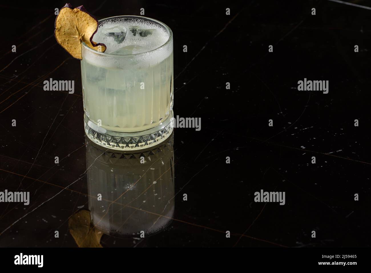 Classic cocktail glass on glass table in night club restaurant. Alcohol ...