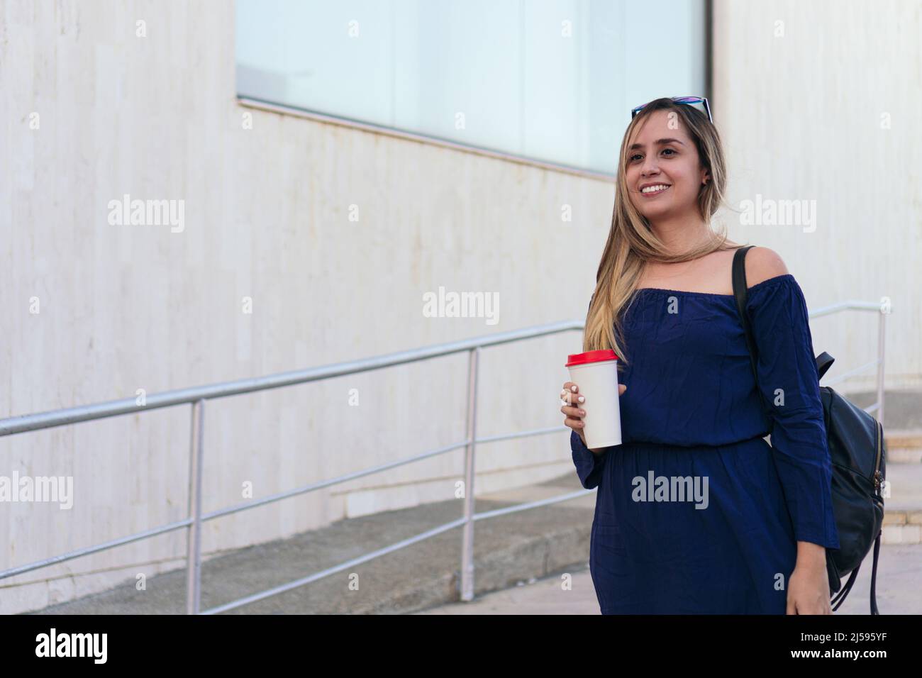 Latin Woman in the city leaving the business building Stock Photo - Alamy
