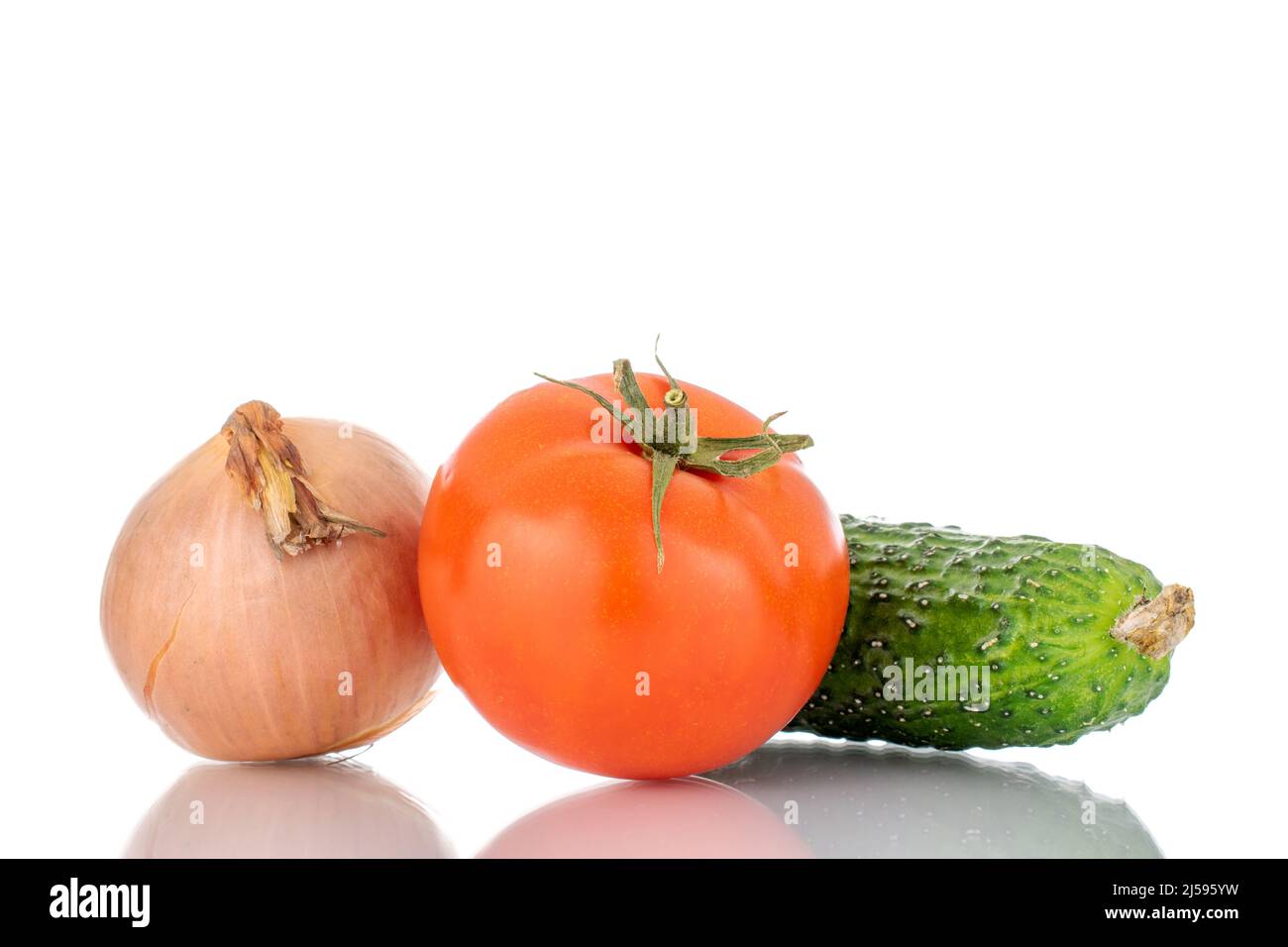One ripe tomato, onion and cucumber, macro, isolated on white ...