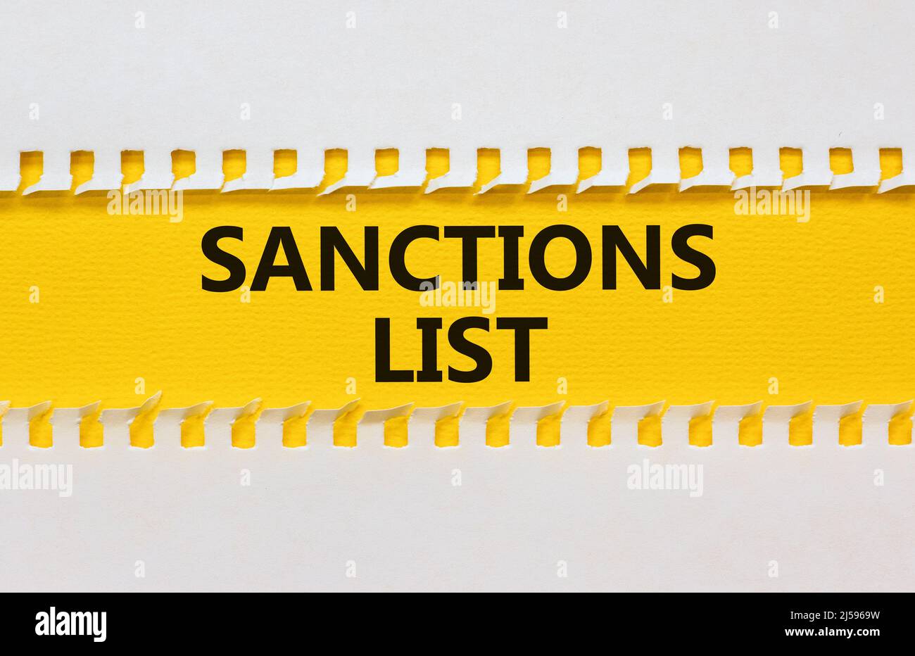Sanctions list symbol. Yellow and white paper with concept words ...