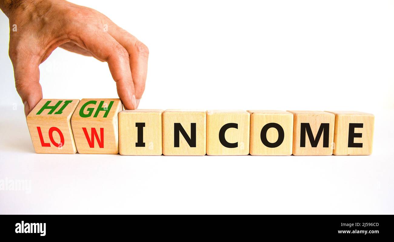 Low or high income symbol. Businessman turns wooden cubes and changes ...
