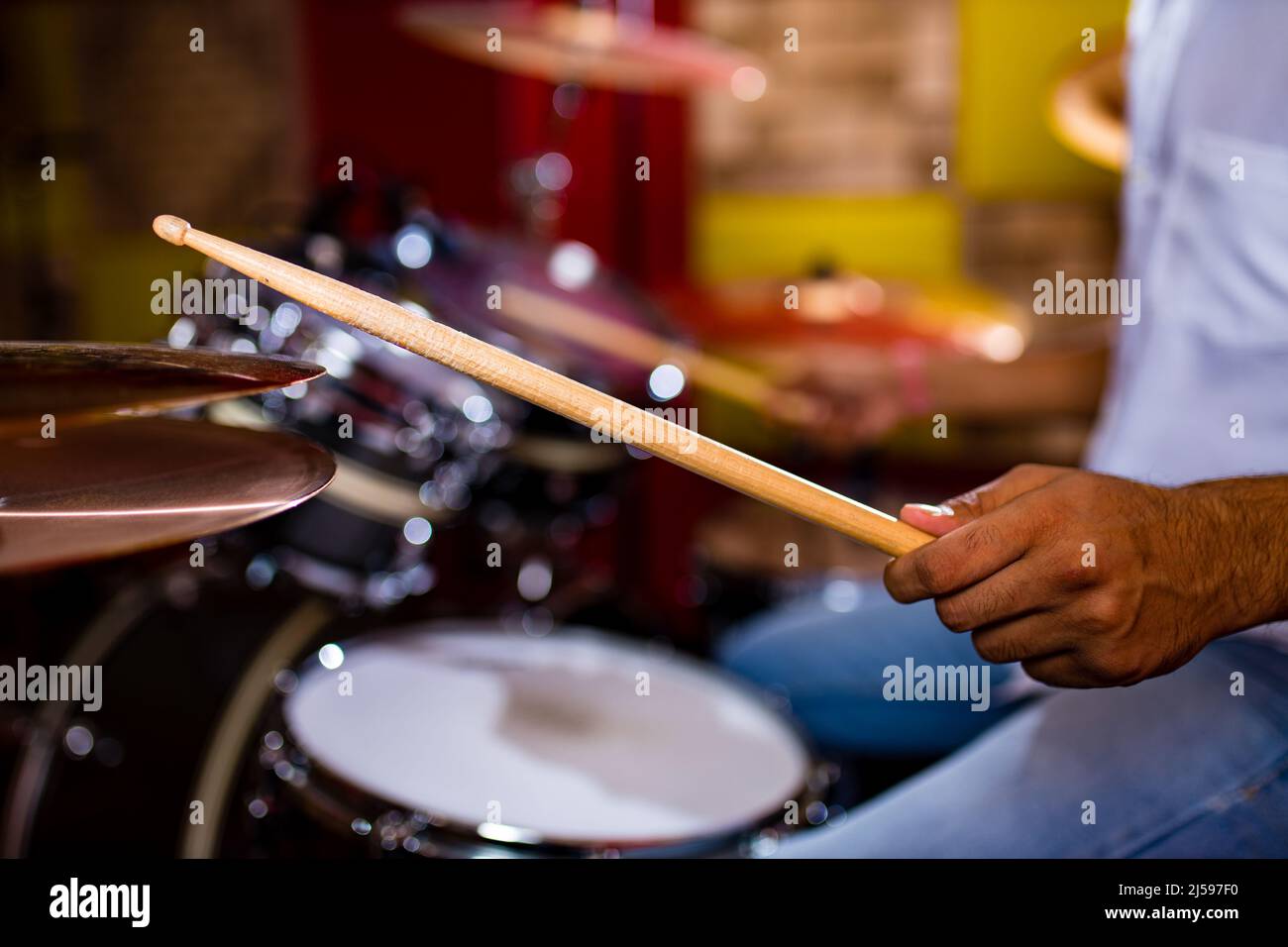 Attractive Teenage Drummer with Drumsticks in recording studio Stock ...