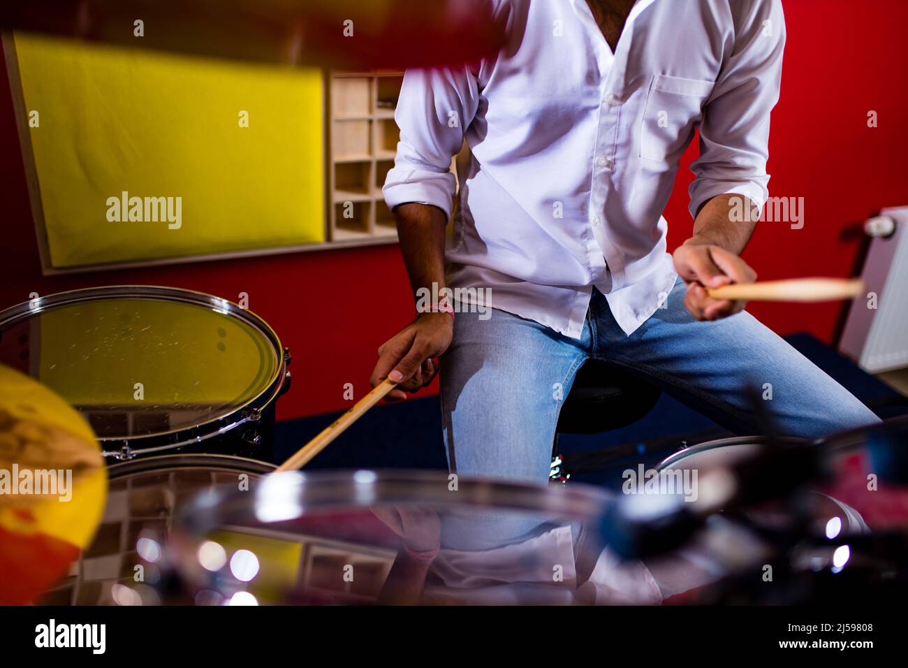 indian man playing the drums sticks close-up in recording studio Stock ...