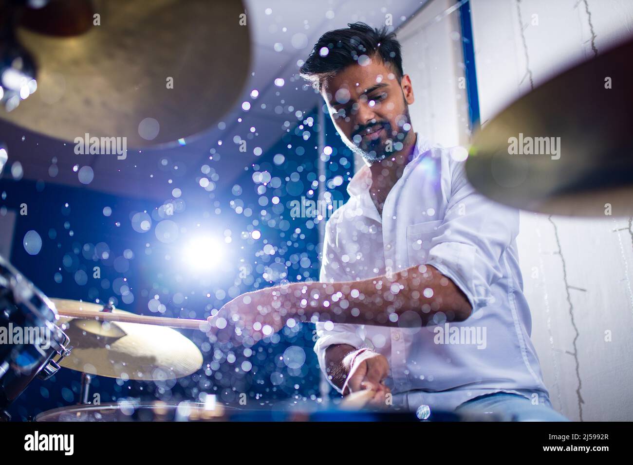 indian man playing the drums sticks close-up in recording studio Stock ...