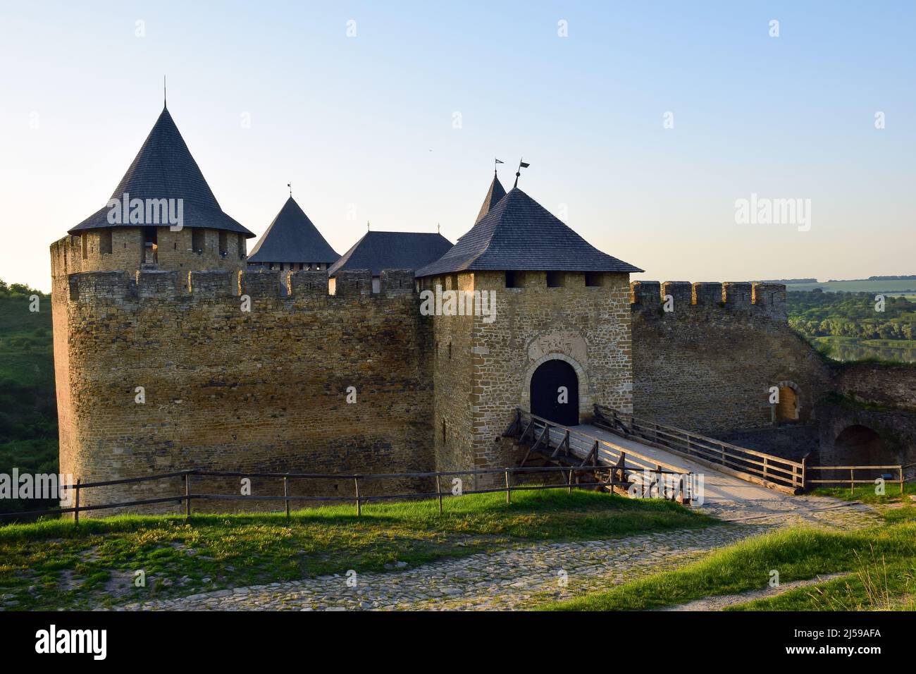 Towers of a medieval stone fortress with battlements, an arched ...