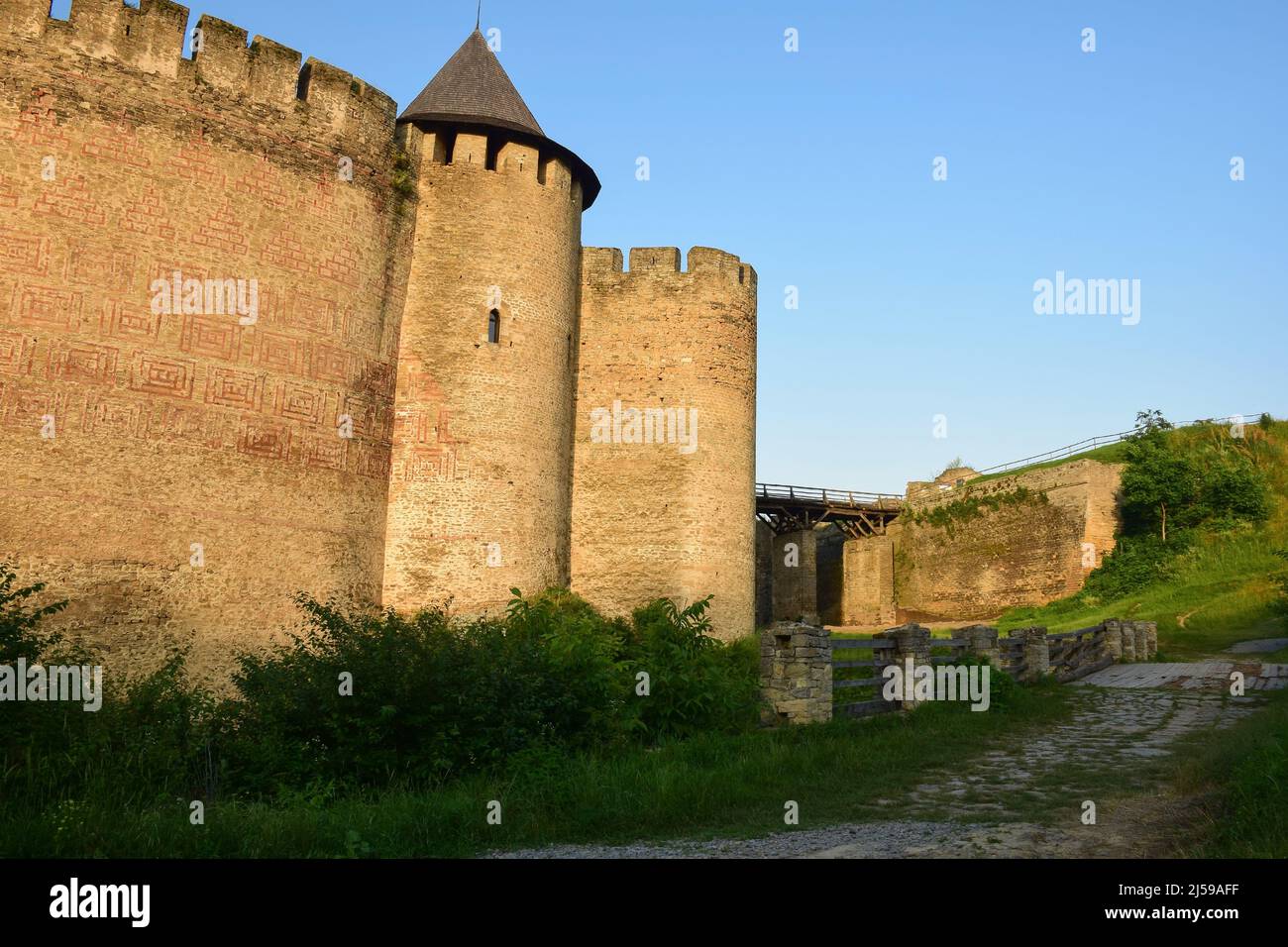 Part of the old stone wall of a medieval fortress with battlements and ...