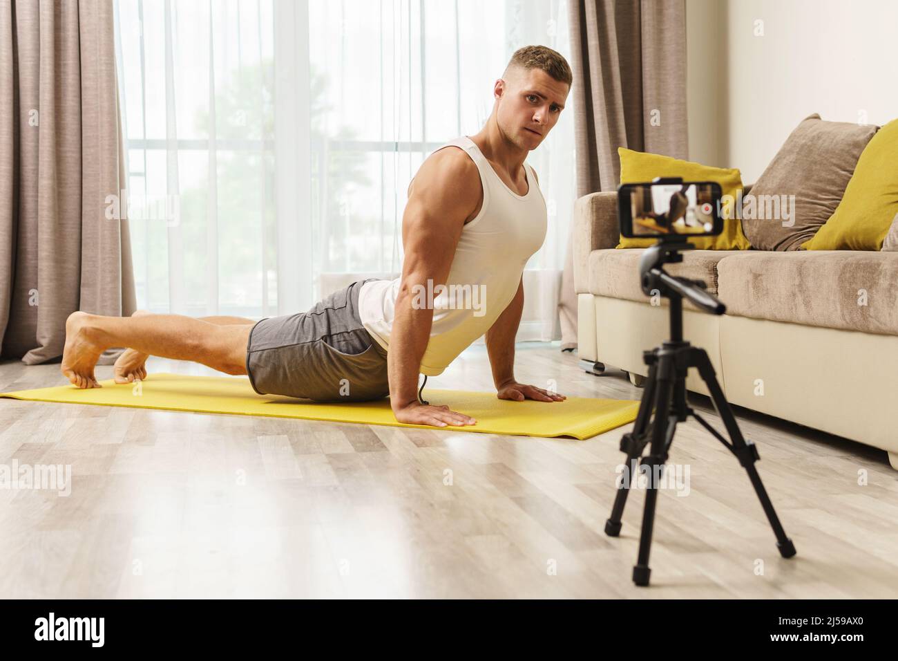 Fitness blogger is streaming or recording video for his subscribers ...