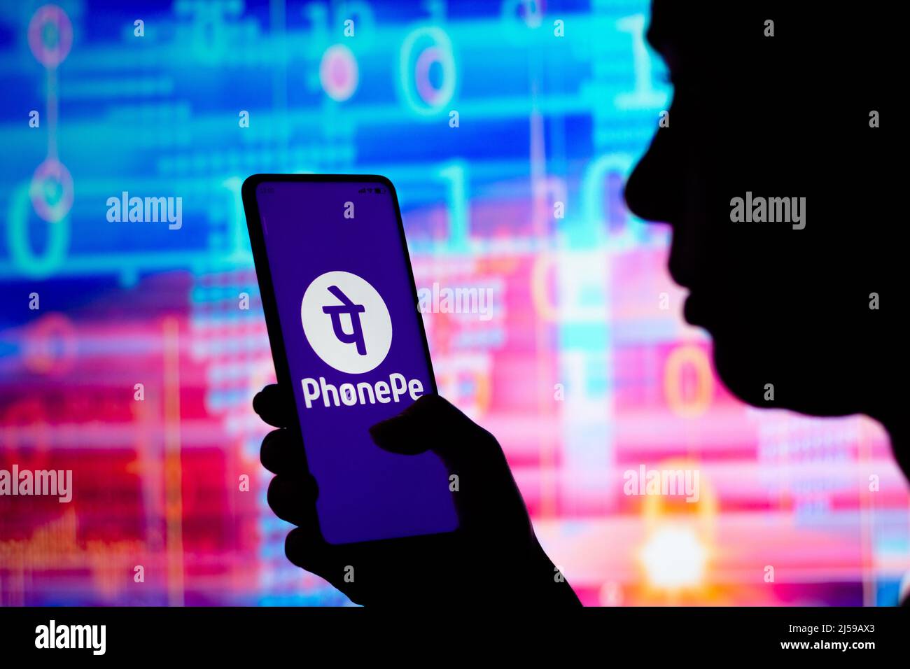 In this photo illustration, a silhouetted woman holds a smartphone with ...