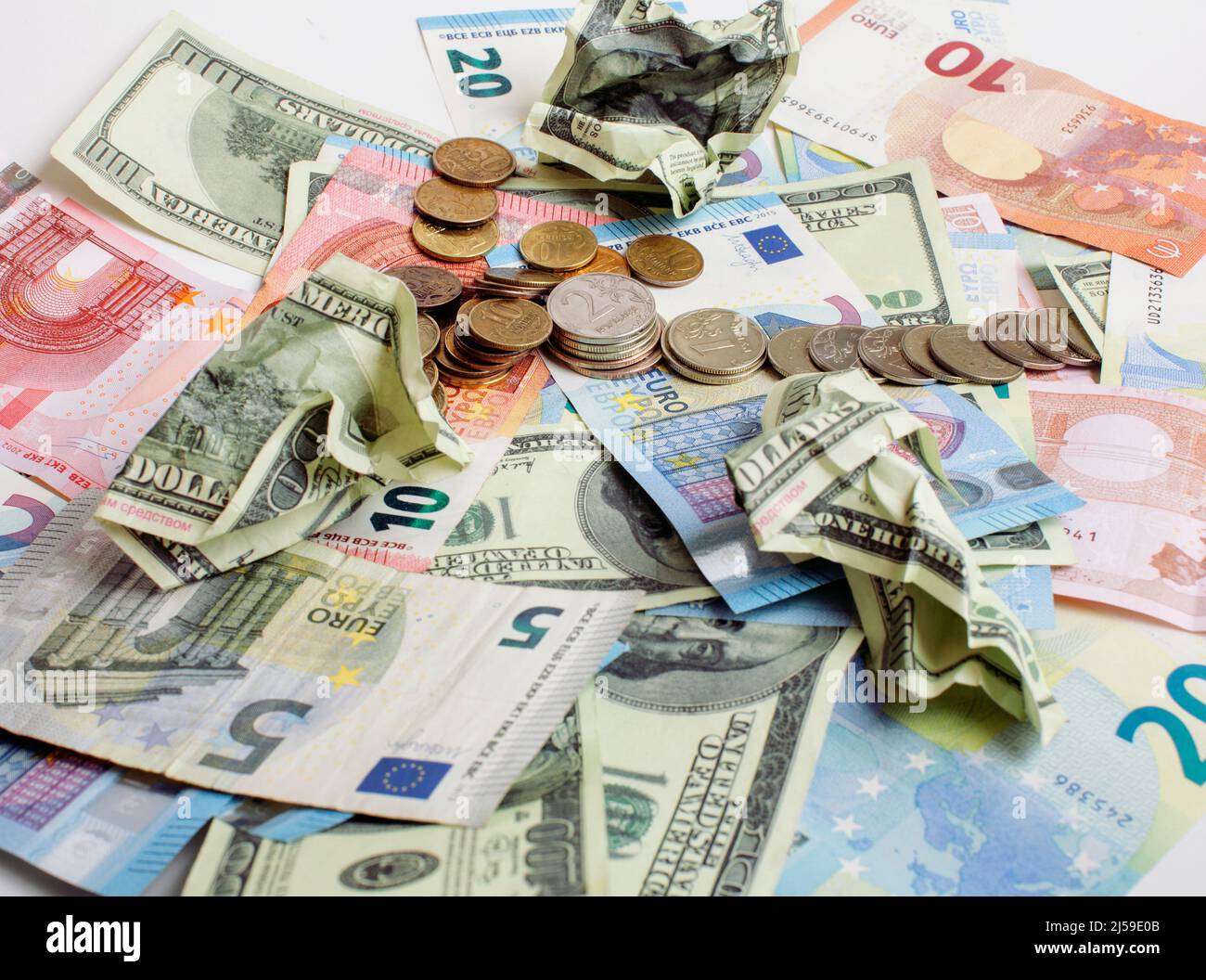 Cash on table isolated: dollars, euro, rubl broken money. All in mess ...