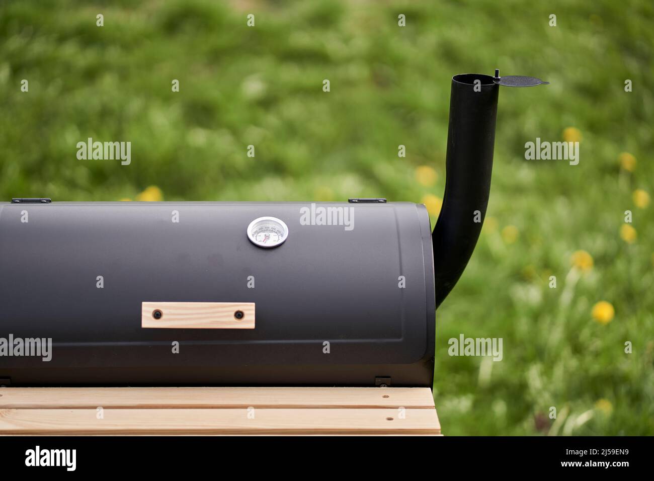 New smoker barbecue grill. Equipment for cooking and smoking. Close up ...