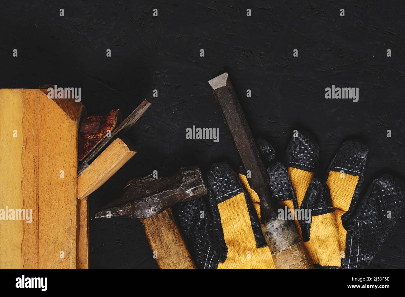 Set of tools for carpenters, hammer, chisel and plane with gloves dark ...