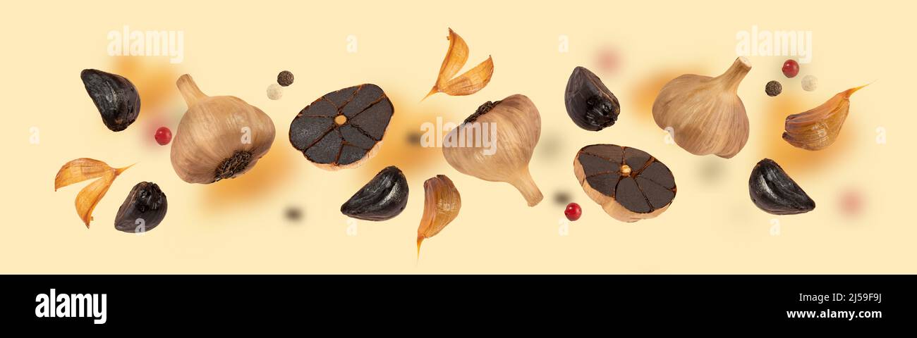 An image of flying black garlic. Black garlic bulbs float in the air on ...