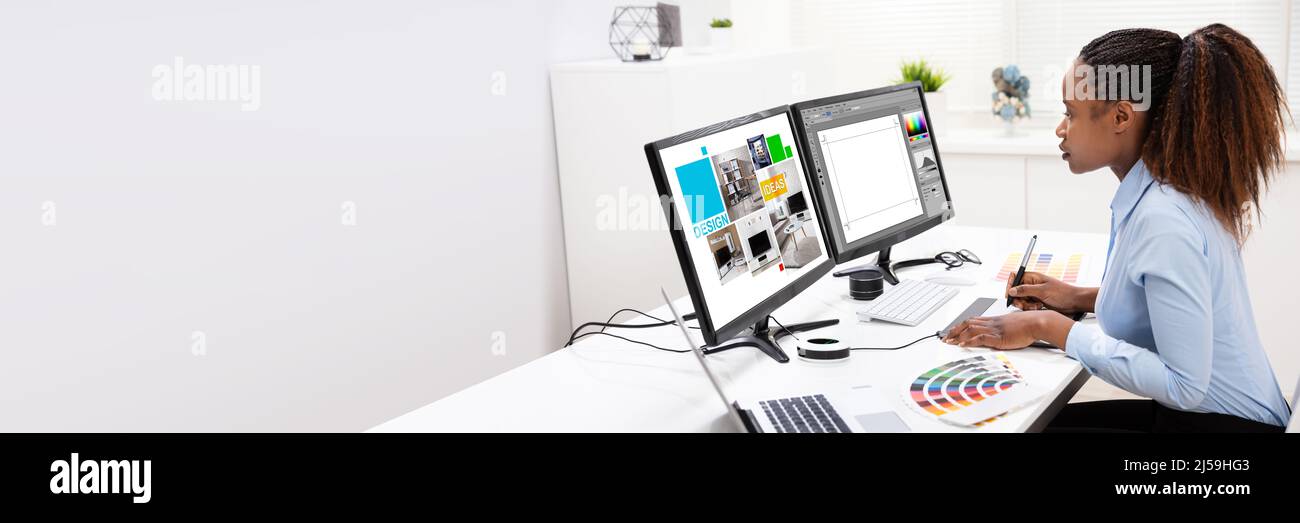 Young Female Designer Editing Photos On Computer In Office Stock Photo ...