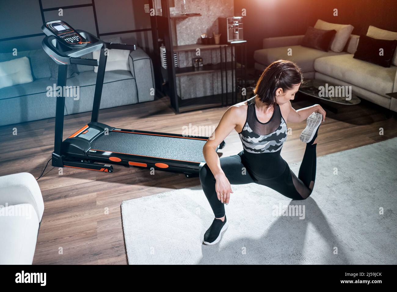 cheerful female stretching and preparing for cardio workout on ...