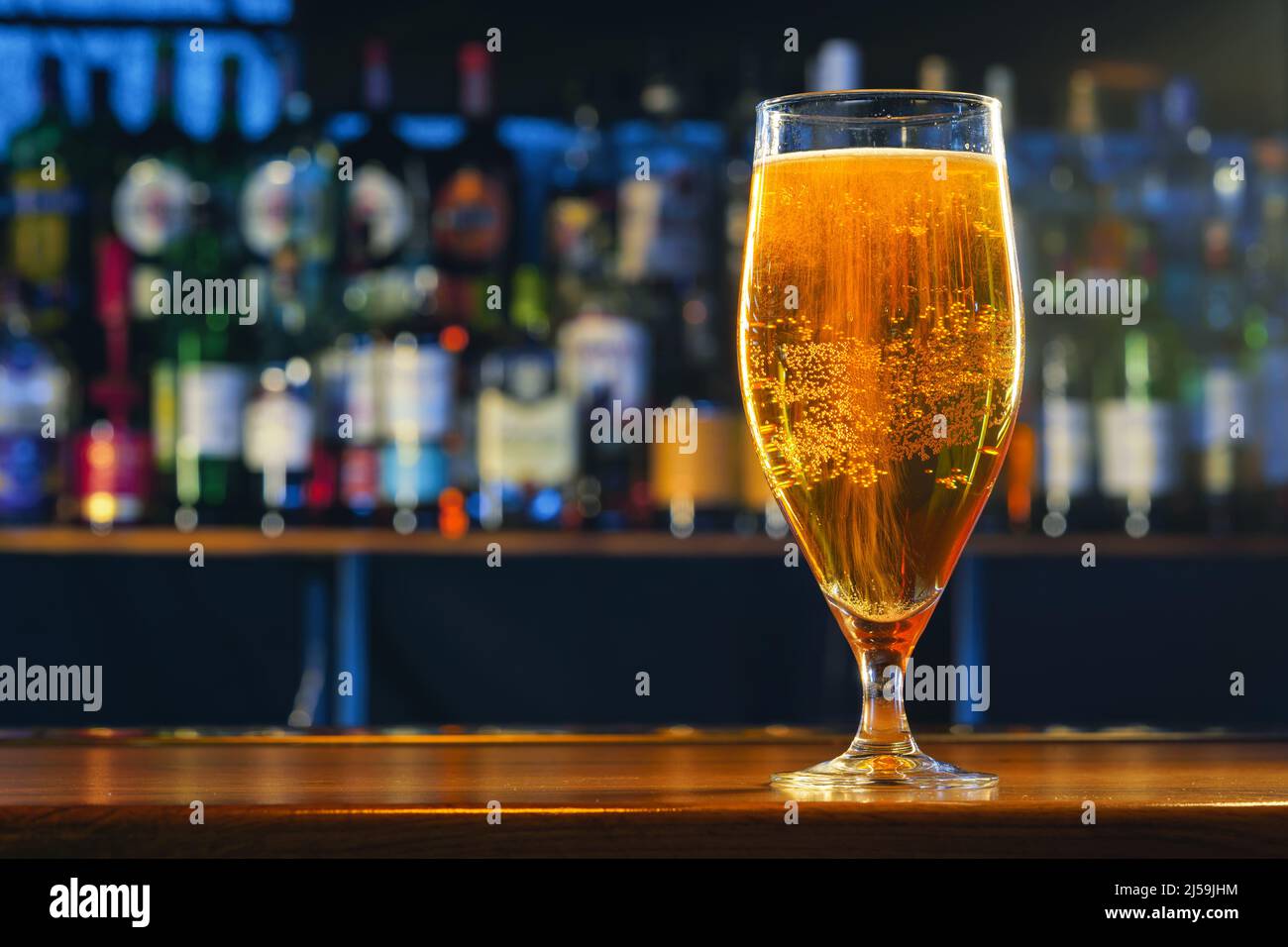 Fresh cold beer in glass on bar background Stock Photo - Alamy