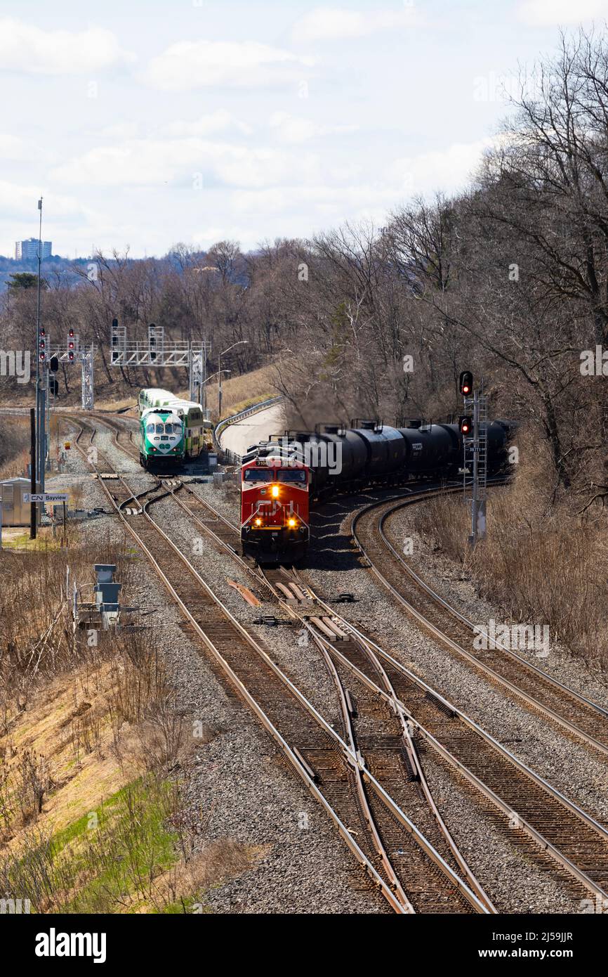 Freight train and commuter passenger train on railway tracks. Hamilton ...