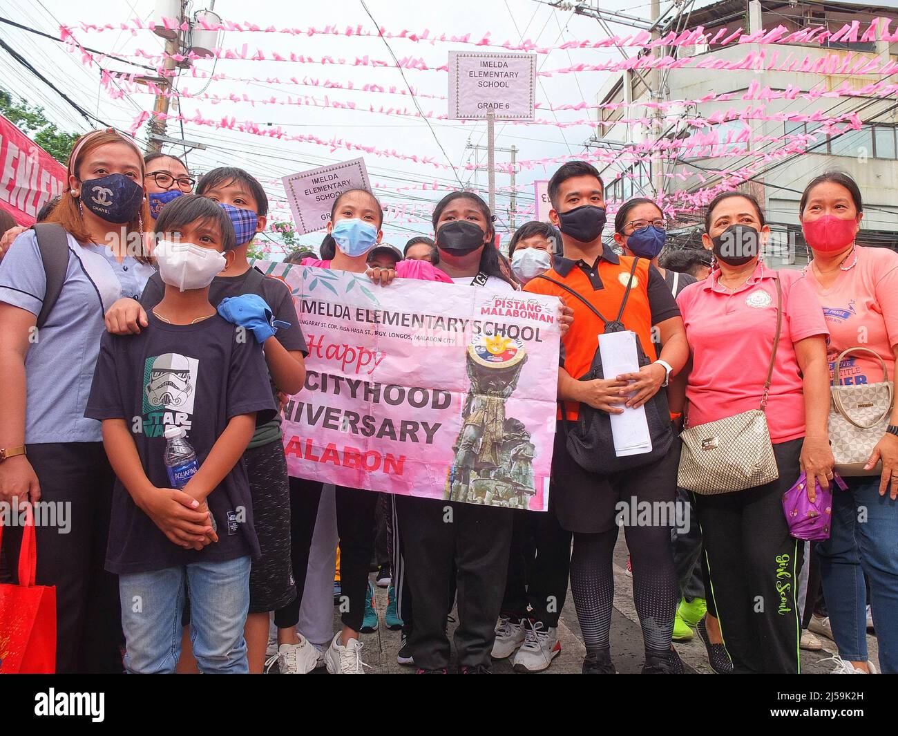 Malabon, Philippines. 21st Apr, 2022. Teachers and students from Imelda Elementary School hold ...