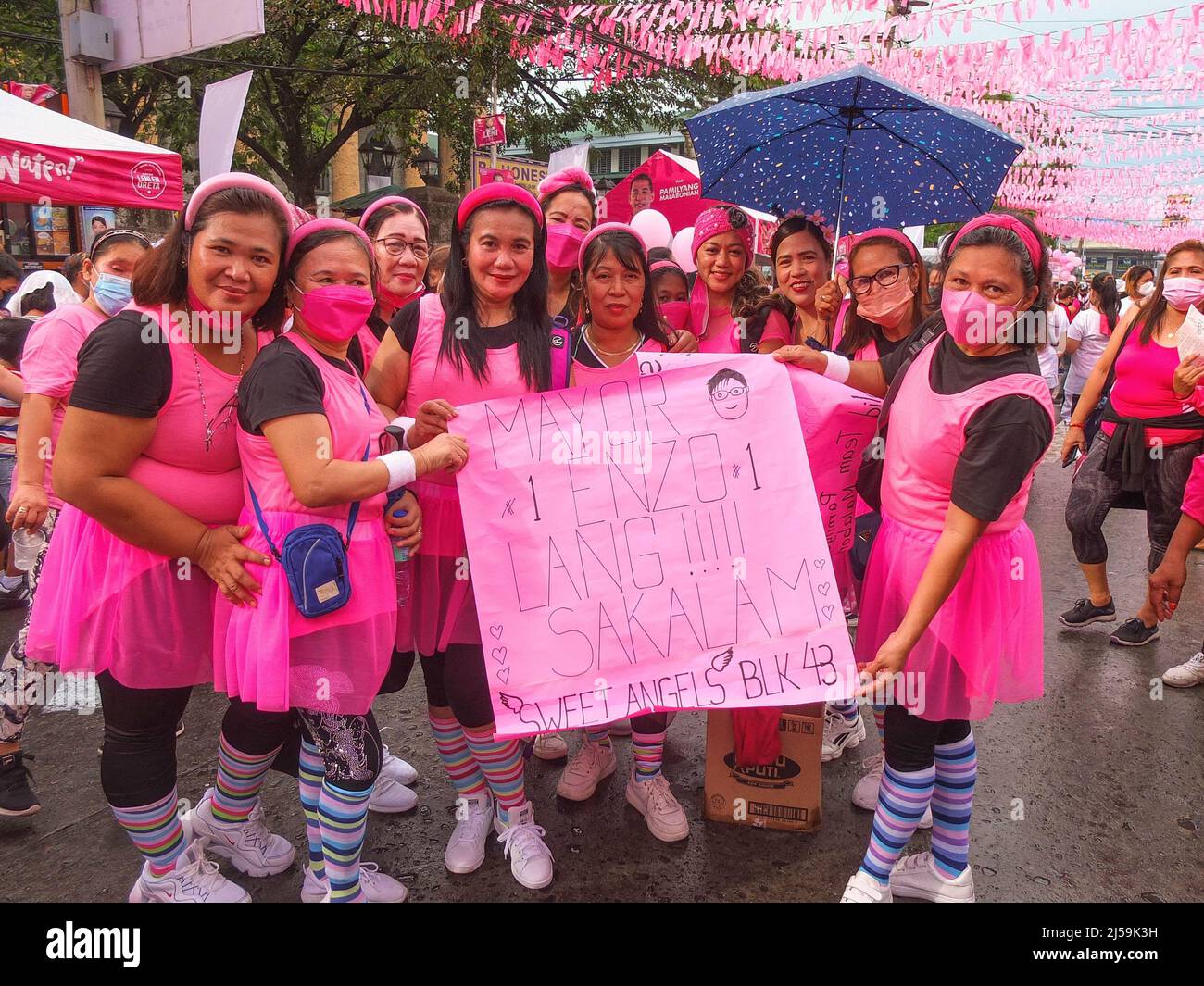 An all female Zumba group hold a placard endorsing Malabon City ...
