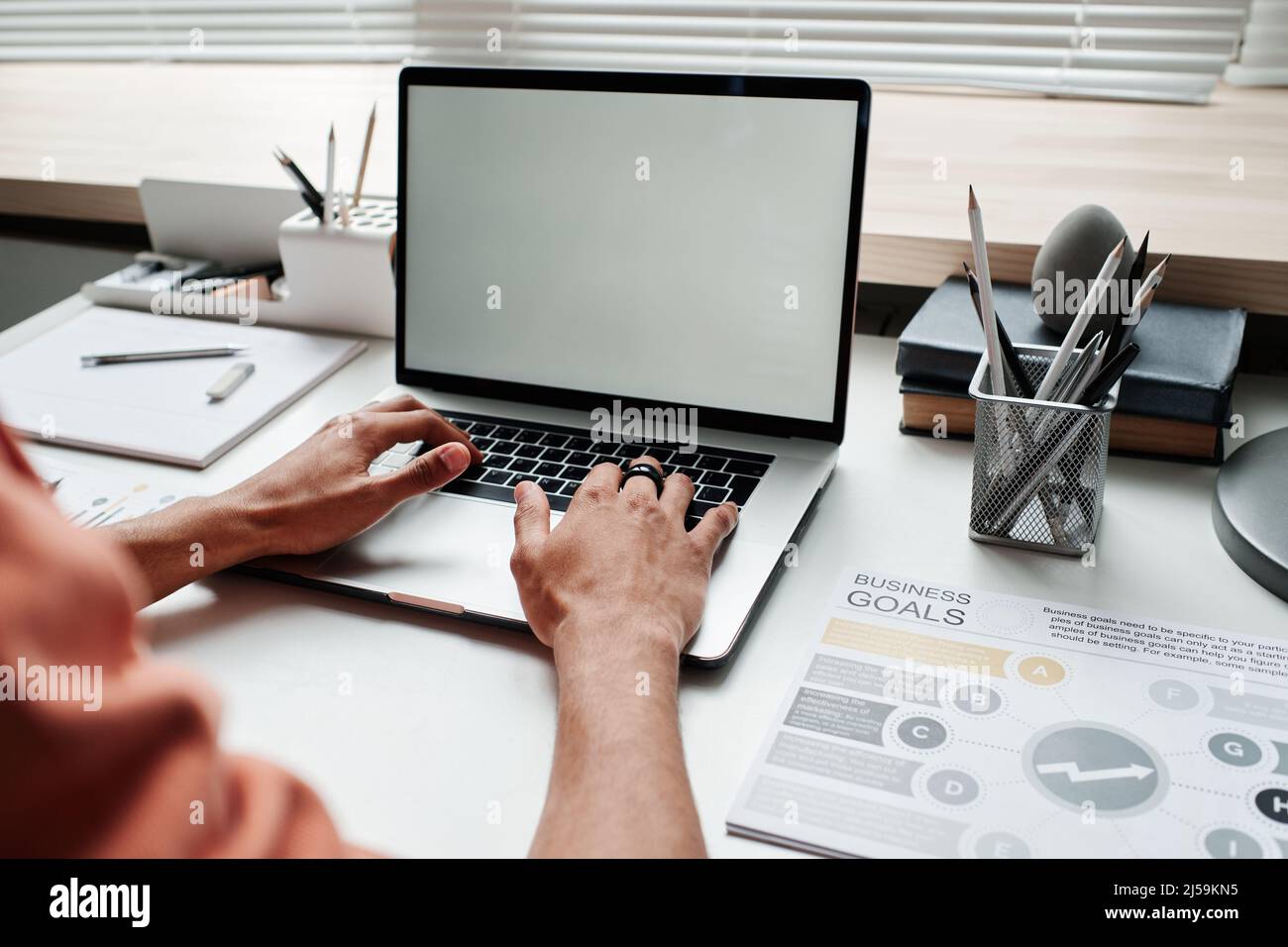 Close-up of unrecognizable manager typing on laptop while preparing ...