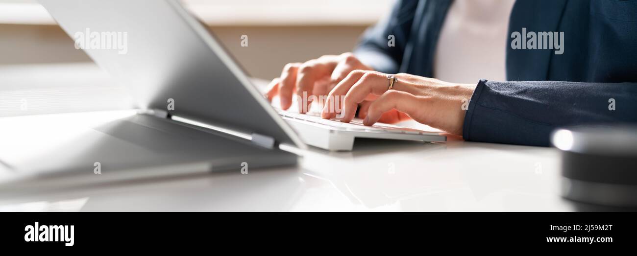 Working On Hybrid Laptop At Desk. Hand Typing On Keyboard Stock Photo ...