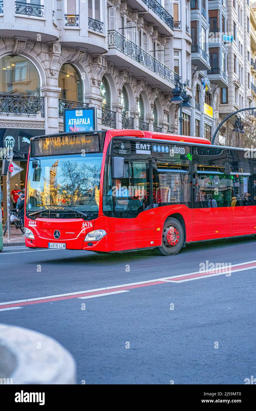 A Mercedes Benz urban transportation bus drives in the old town ...